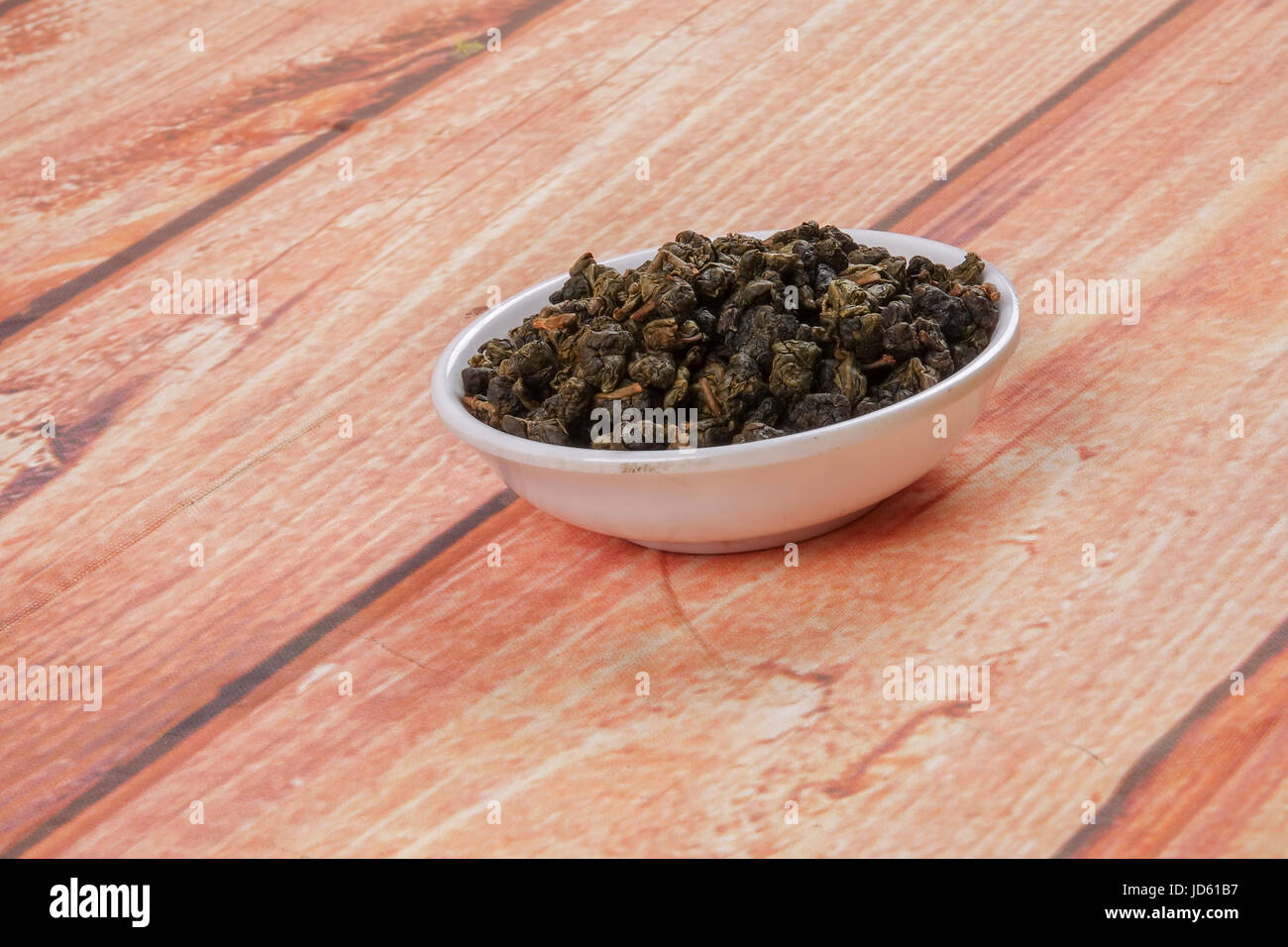 dried chinese tea leaves in a small bowl over wooden background Stock ...