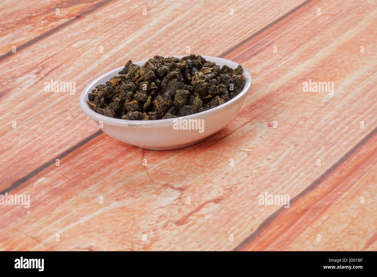 dried chinese tea leaves in a small bowl over wooden background Stock ...