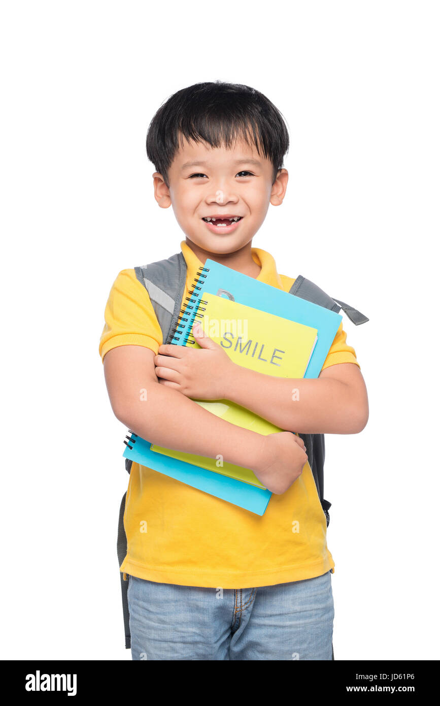 Portrait of cute smiling boy with backpack and colorful books ...