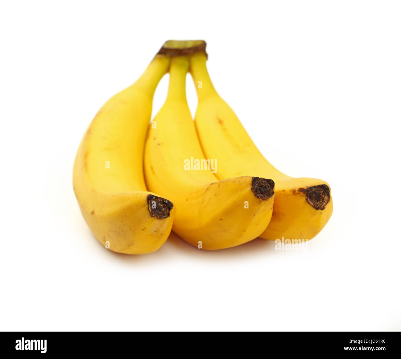Bunch of three fresh yellow bananas isolated on white background, close ...