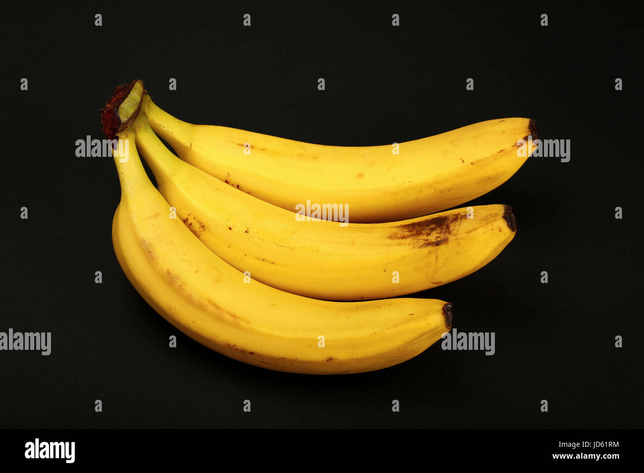 One fresh ripe yellow banana isolated on black paper background, close ...