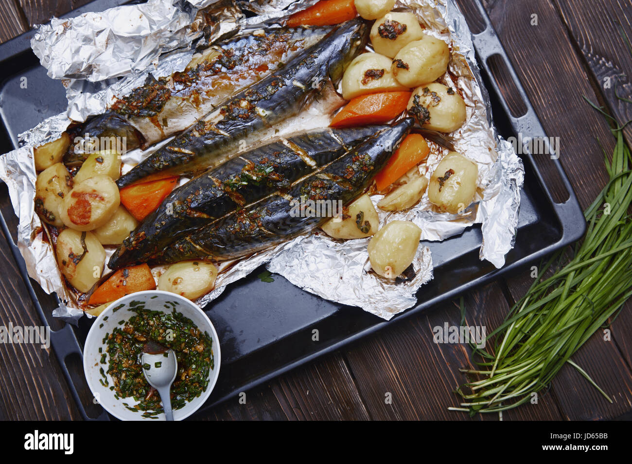 Baked fish and vegetable Stock Photo - Alamy