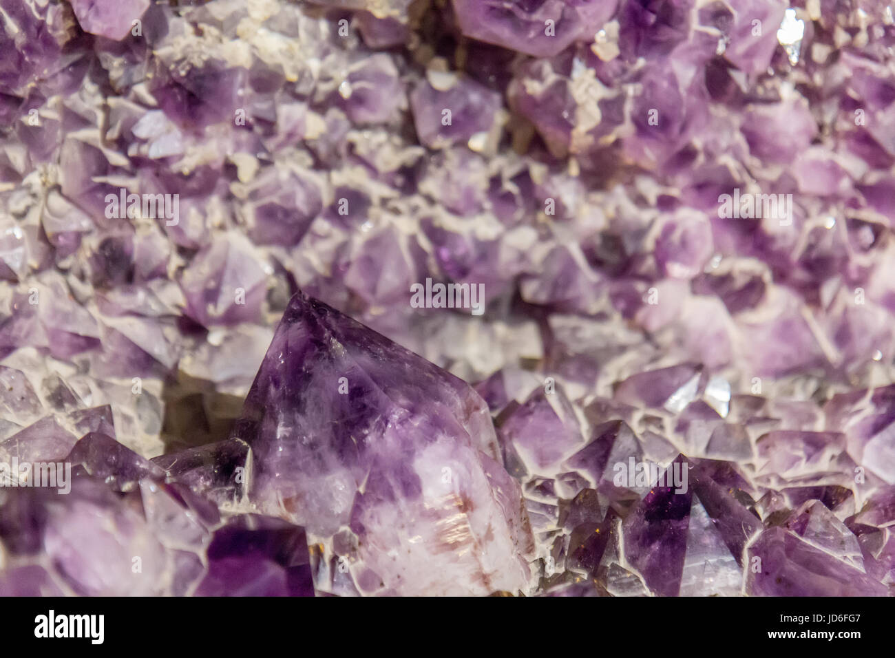Natural amethyst crystal background Stock Photo - Alamy