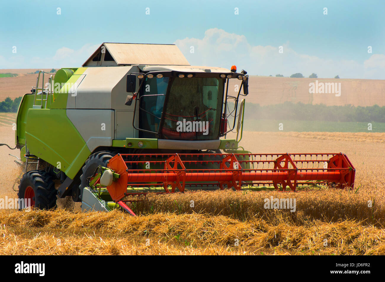 Grain harvesting with combine harvester. Wheat field Stock Photo - Alamy