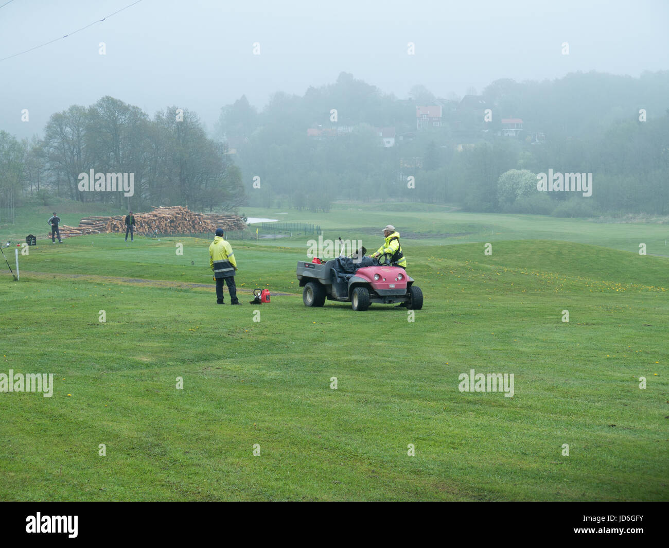 working on a golf course one very foggy day Stock Photo - Alamy