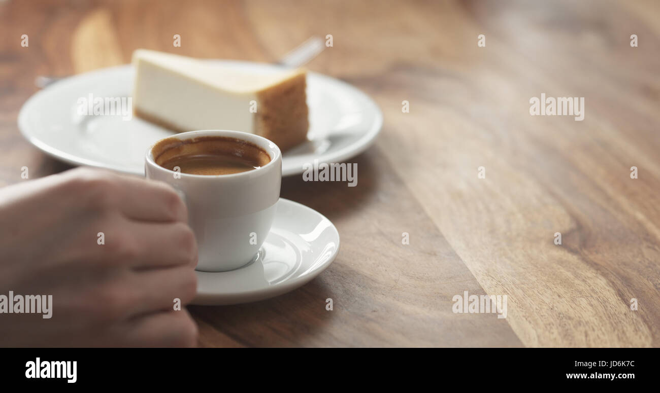 man hand eating cheesecake and drink coffee Stock Photo - Alamy