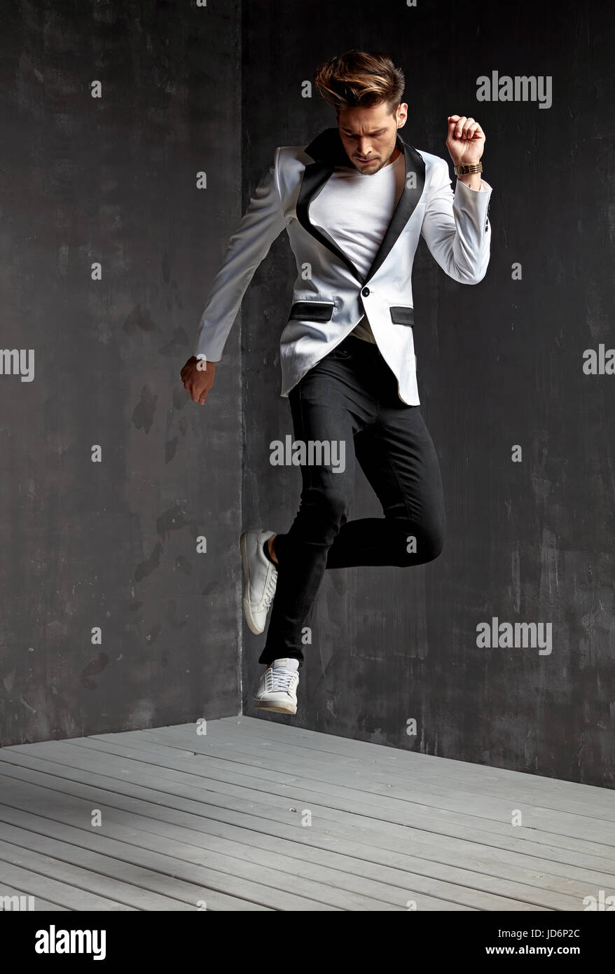 Handsome young man dancing on the wooden floor Stock Photo - Alamy