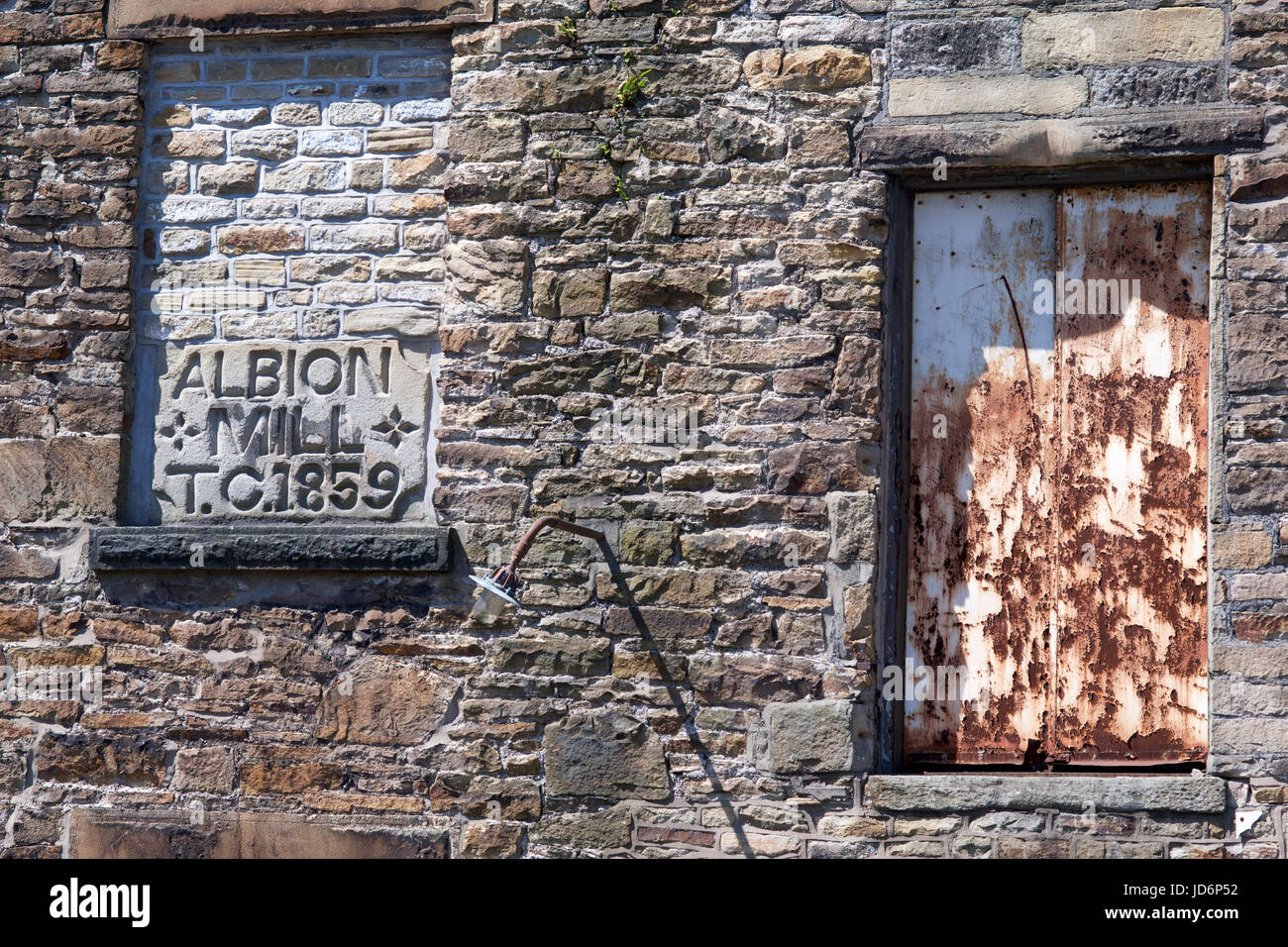 A sign showing the location of Albion Mills in New Mills, Derbyshire ...