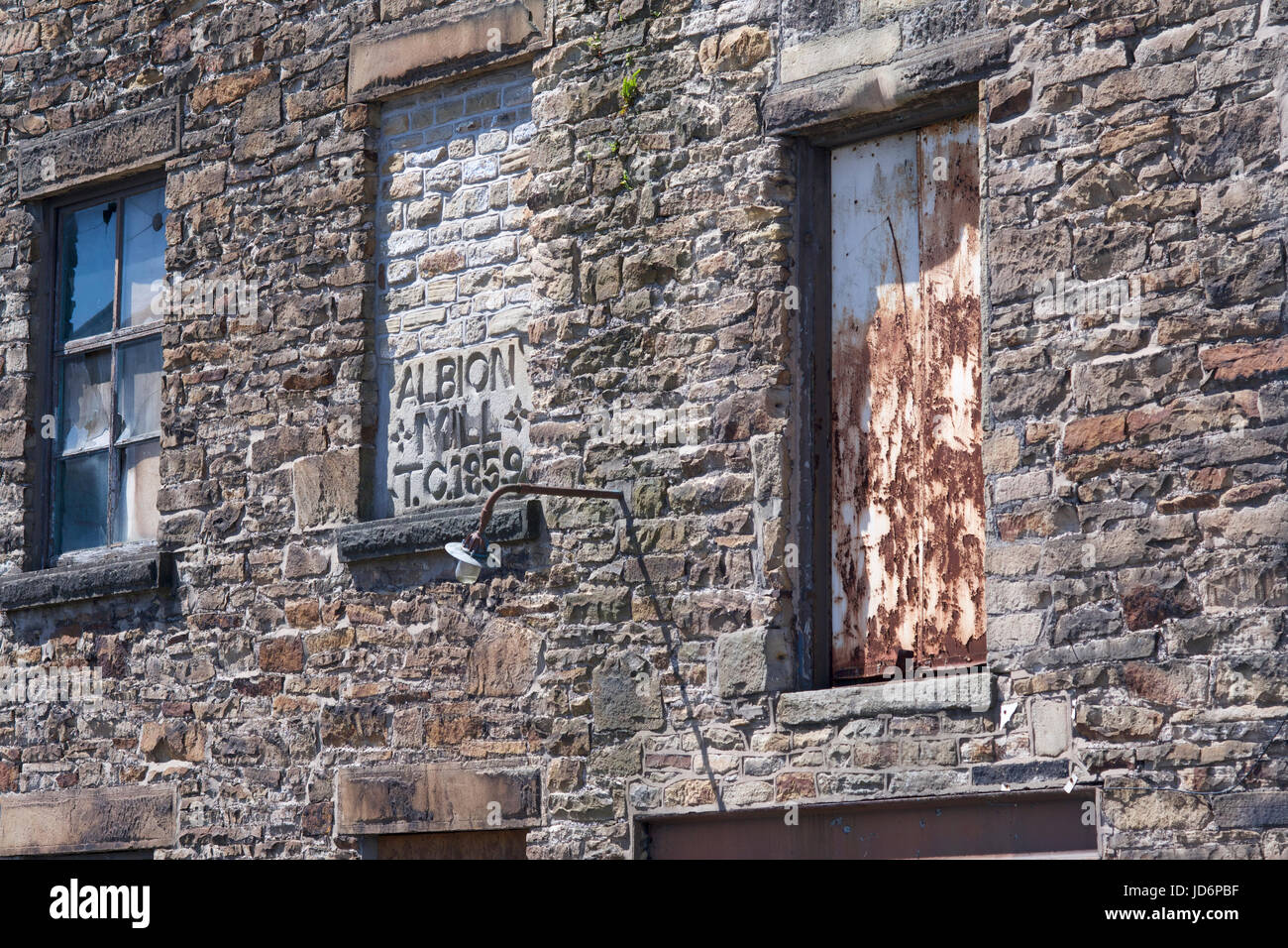 A sign showing the location of Albion Mills in New Mills, Derbyshire ...