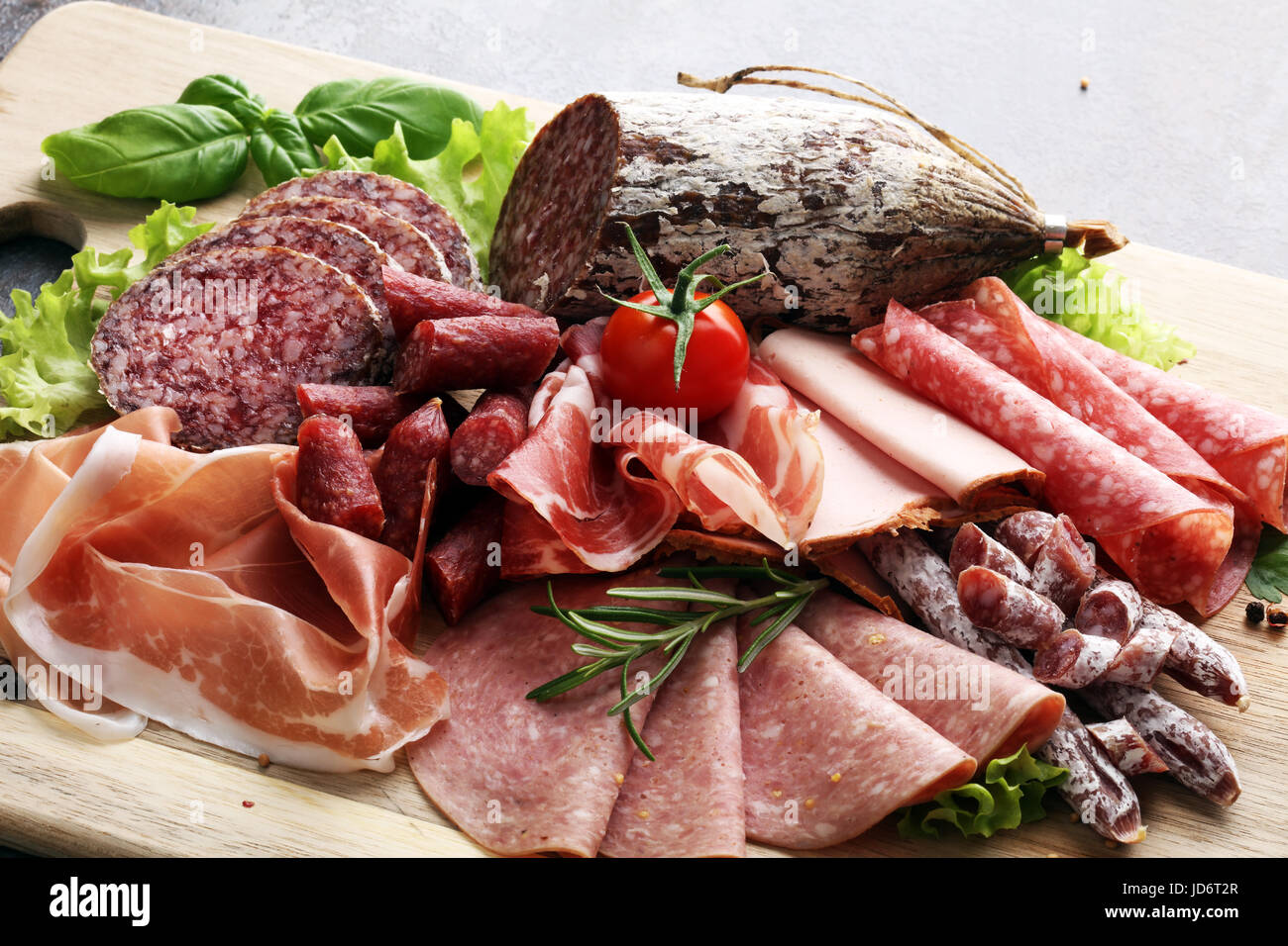 Food tray with delicious salami, pieces of sliced ham, sausage ...
