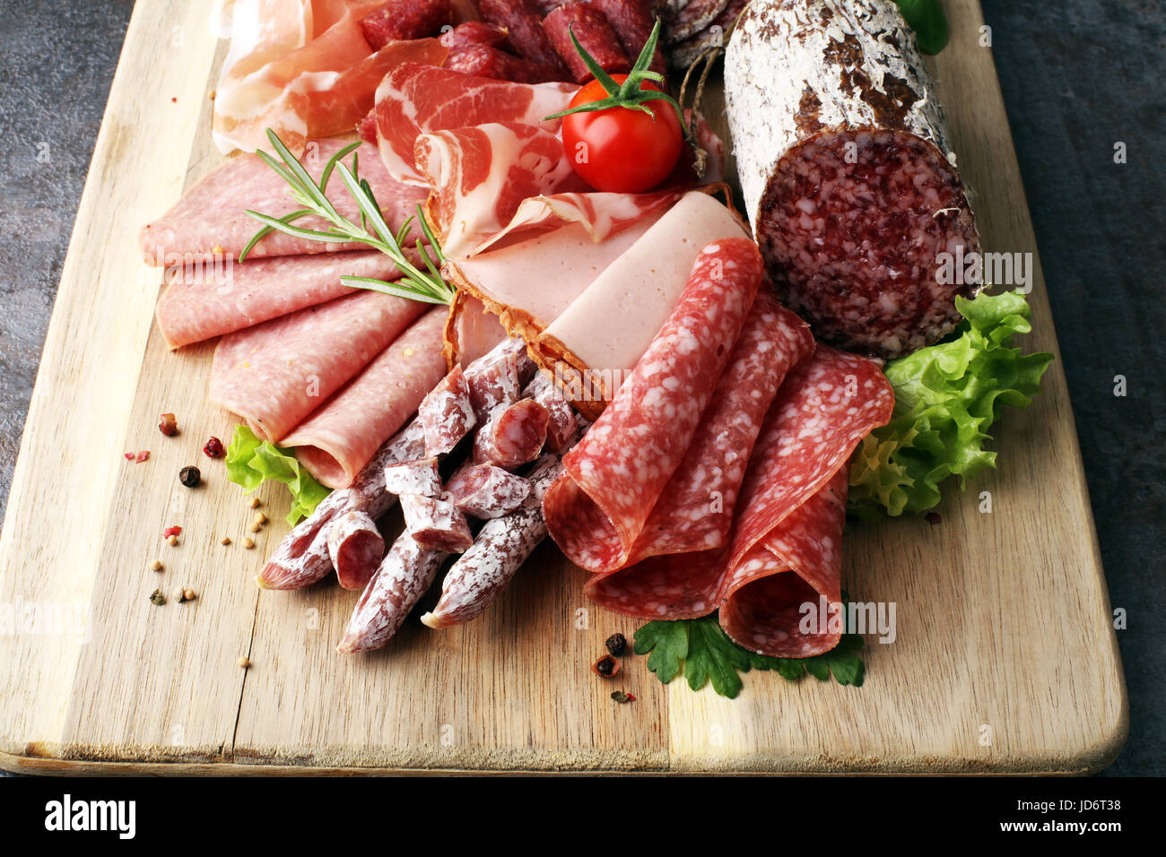 Food tray with delicious salami, pieces of sliced ham, sausage ...