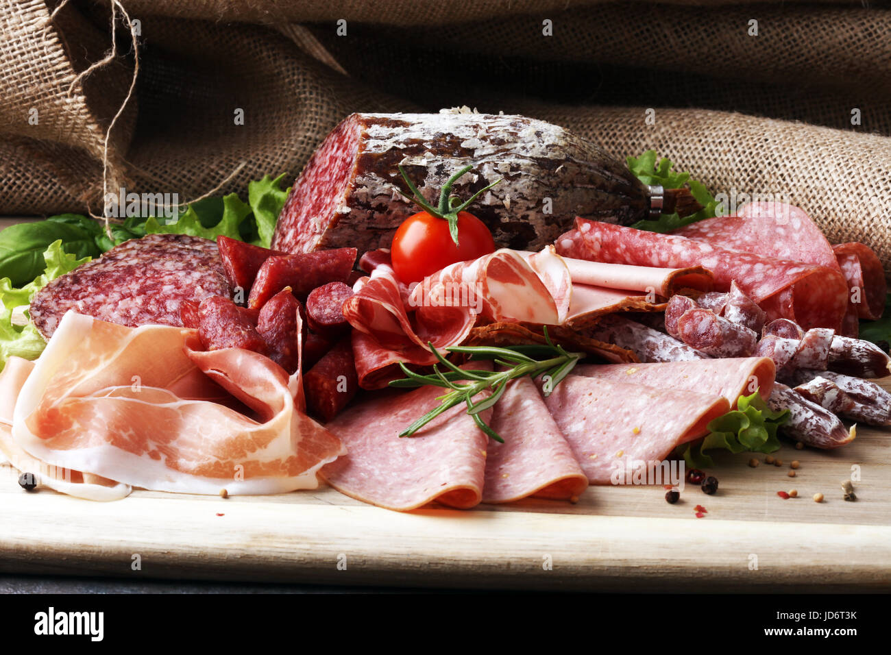 Food tray with delicious salami, pieces of sliced ham, sausage ...
