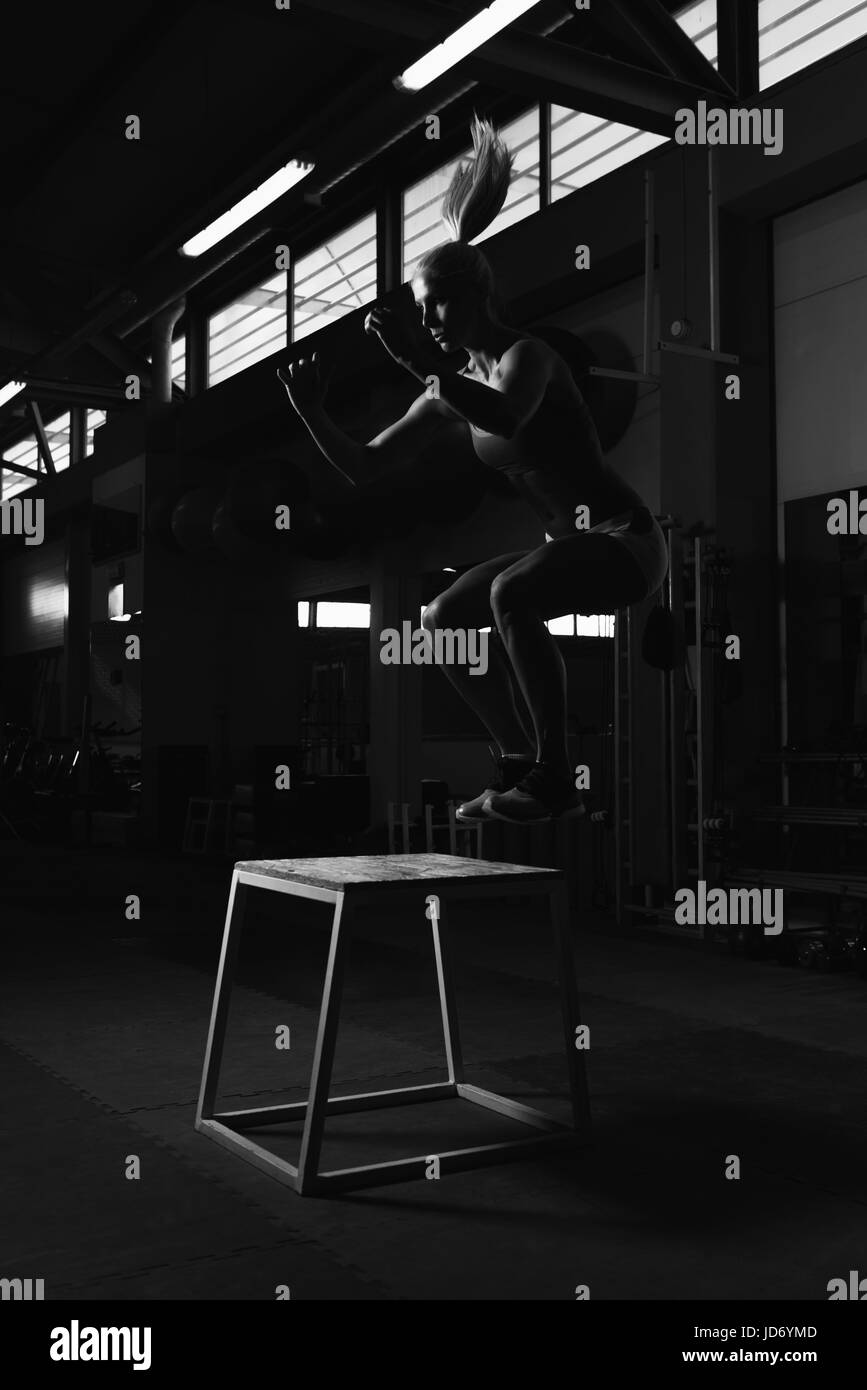 Fit Young Woman Doing Box Jumping At A Style Gym - Female Athlete Is ...