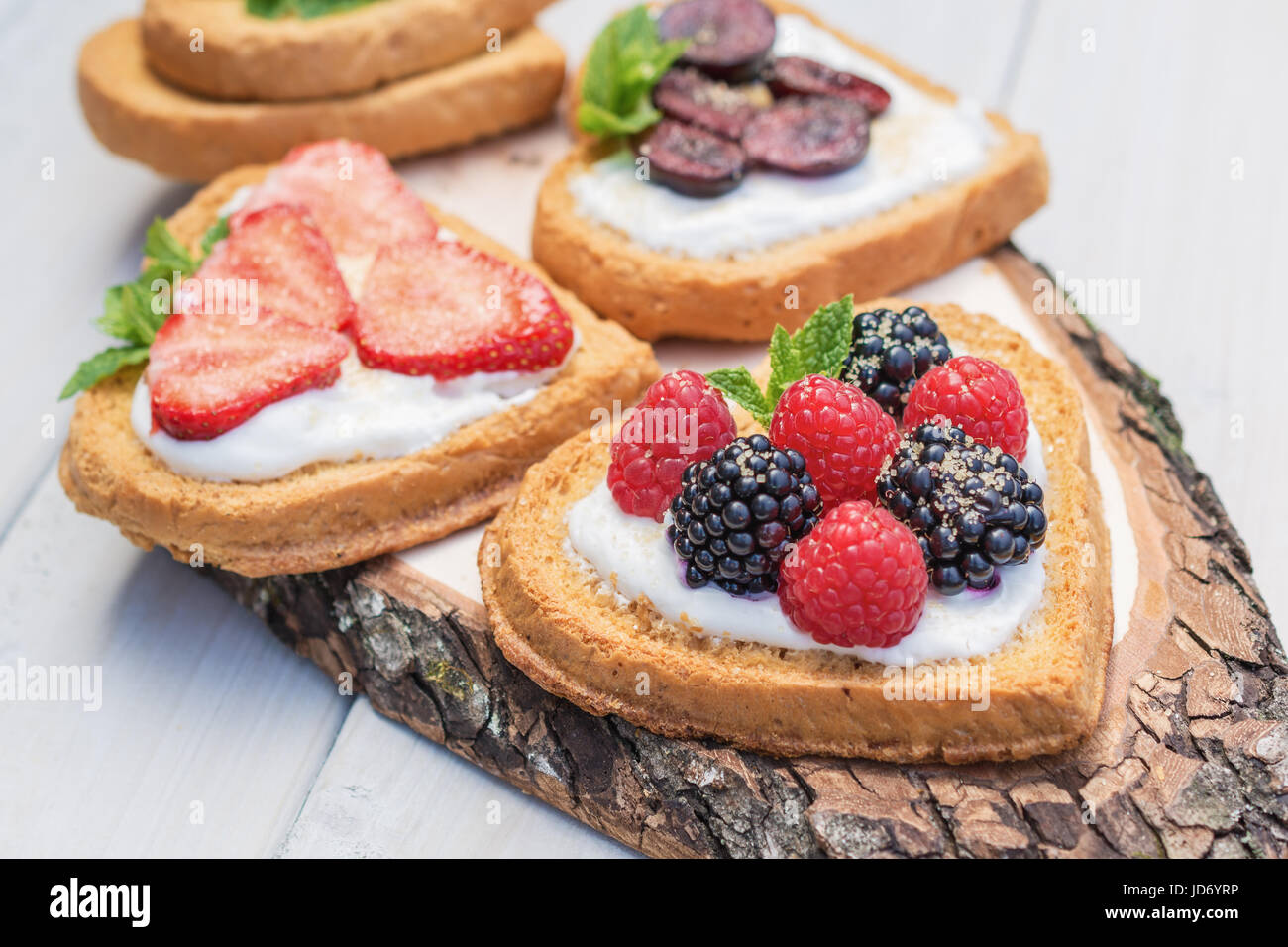 Heart shaped biscuits spread with quark, strawberries, blackberries ...
