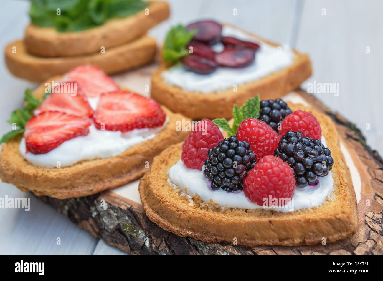 Heart shaped biscuits spread with quark, strawberries, blackberries ...