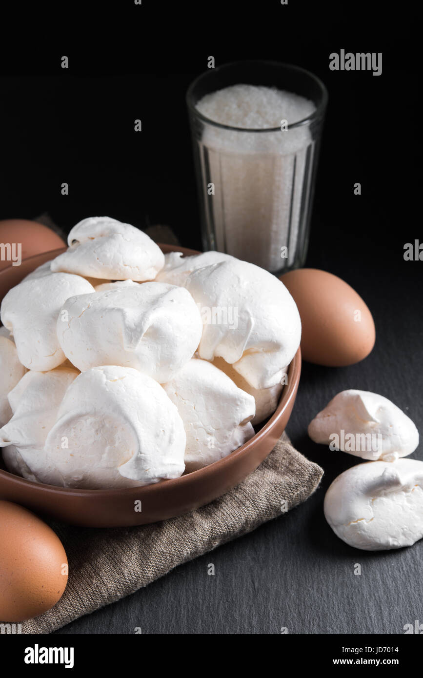 Fresh delicious baked meringue with ingredients on black Stock Photo ...