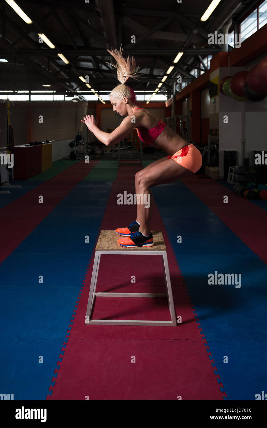 Fit Young Woman Doing Box Jumping At A Style Gym - Female Athlete Is ...