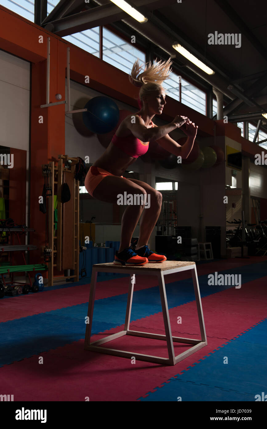 Fit Young Woman Doing Box Jumping At A Style Gym - Female Athlete Is ...