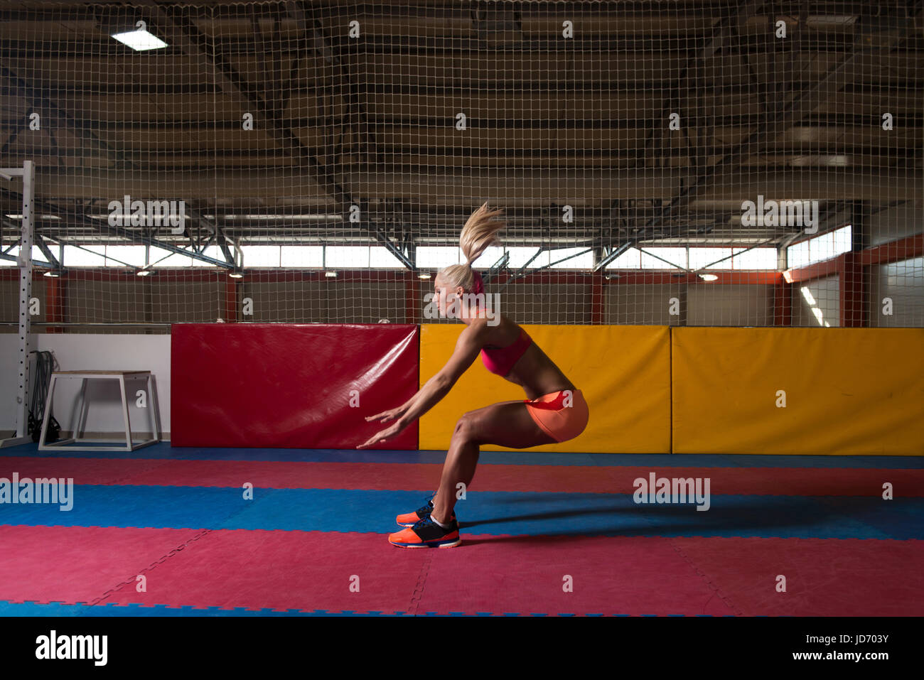 Female Athlete Performing a Long Jump in Gym - One of the Best Jumping ...