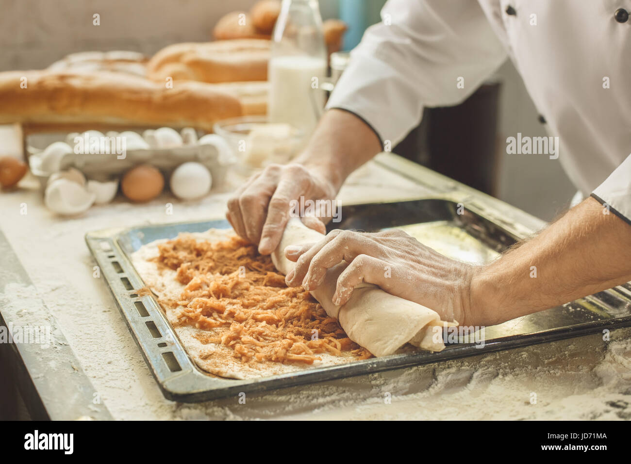 Bakery chef cooking bake in the kitchen professional making roll Stock ...