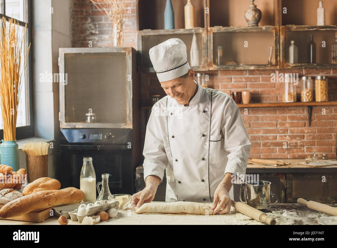 Bakery chef cooking bake in the kitchen professional making roll Stock ...