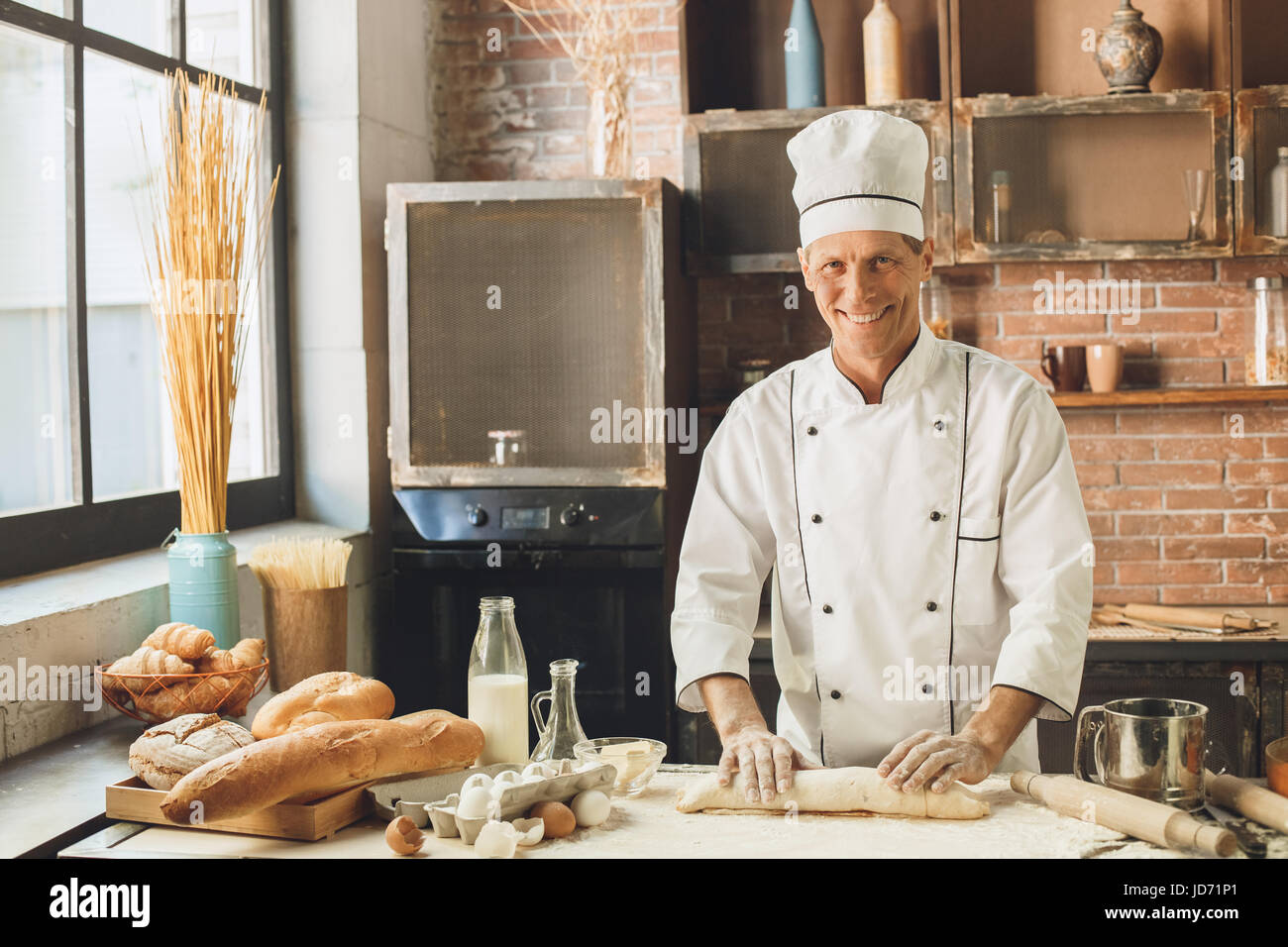 Bakery chef cooking bake in the kitchen professional making roll Stock ...