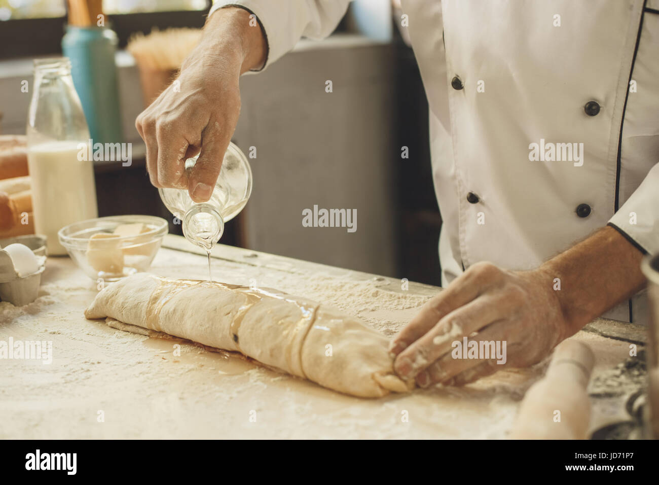 Bakery chef cooking bake in the kitchen professional making roll Stock ...
