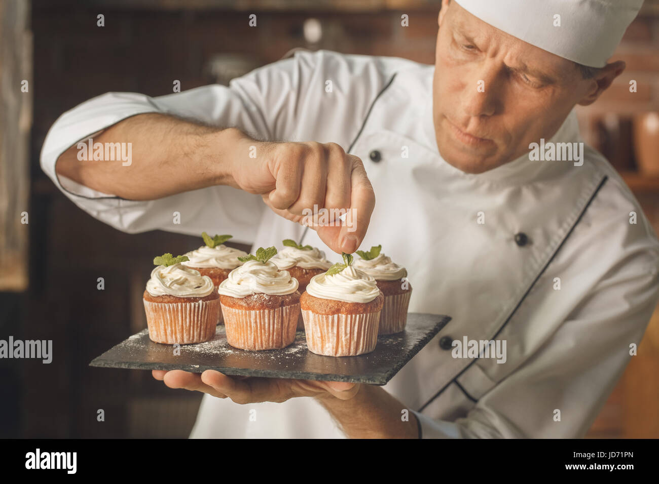 Bakery chef cooking bake in the kitchen professional decorating Stock ...