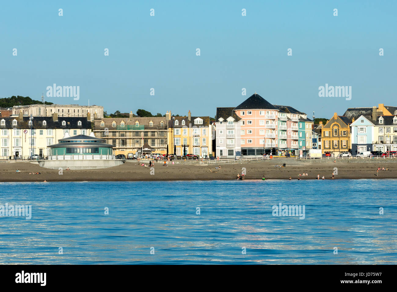Aberystwyth seafront properties and bandstand, with people on the beach ...