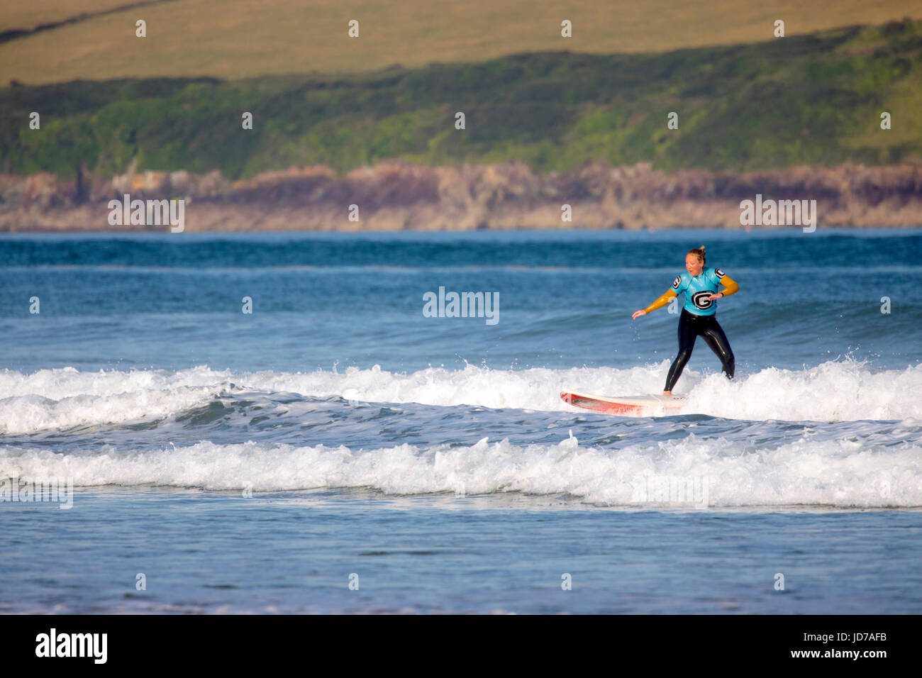 Female surfer holding surf board during hot summer weather at the ...
