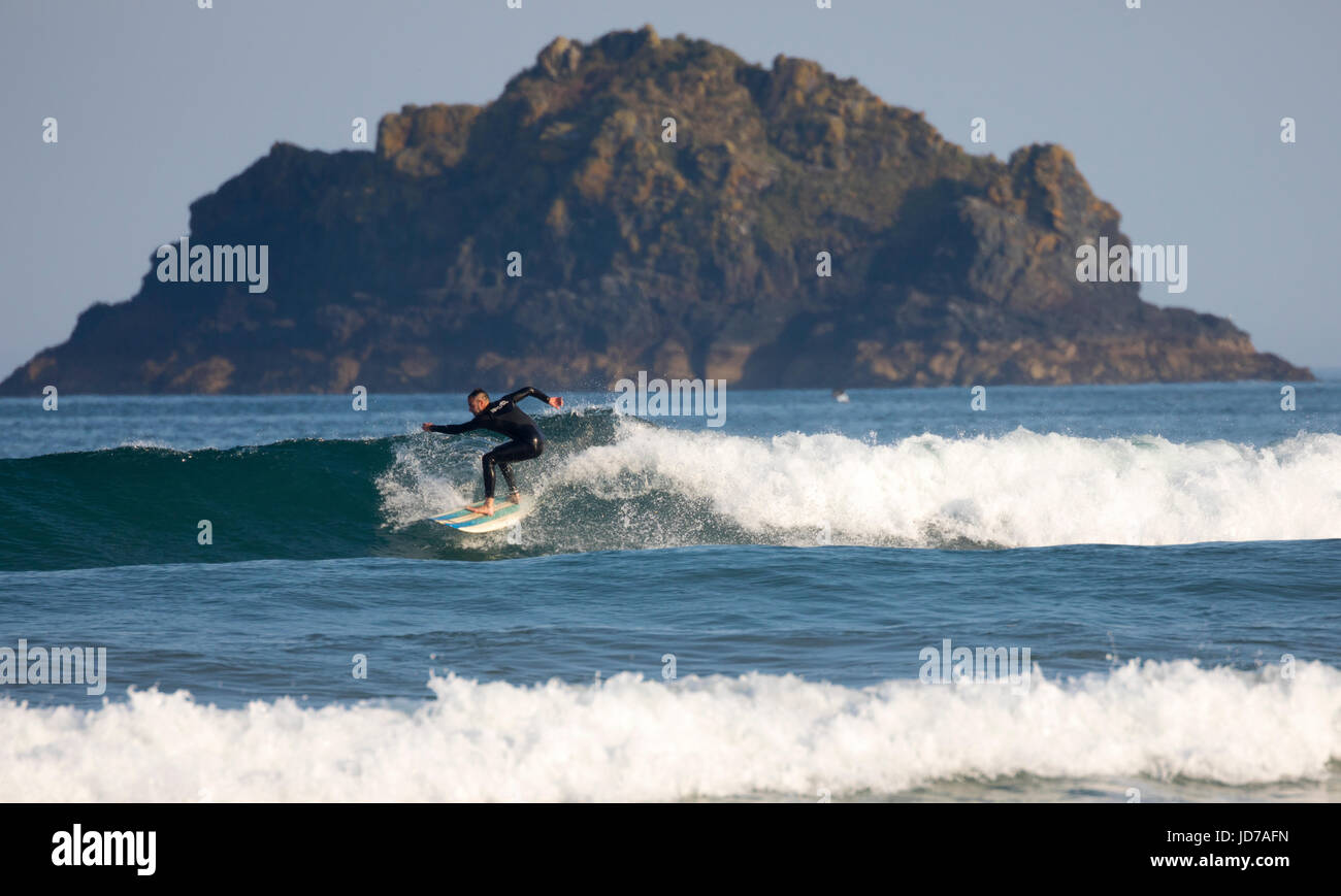 A surfer riding a wave during a summers morning at the renowned UK ...