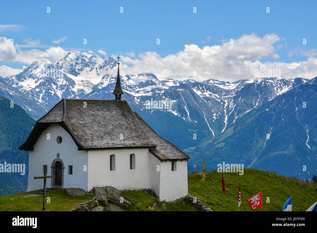 An old white chapel with the mountains in the background in Switzerland ...