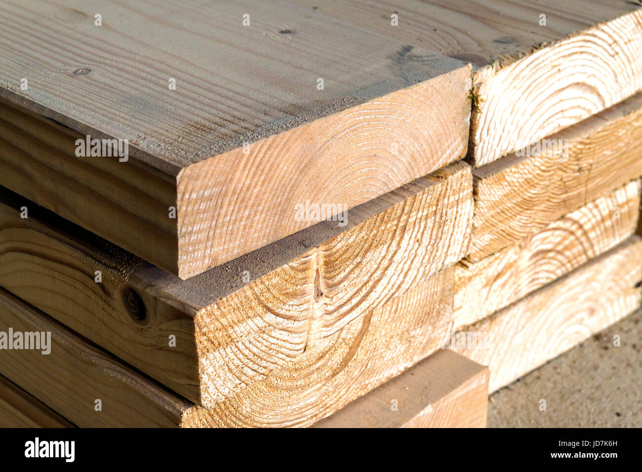 Stack of new wooden studs at the lumber yard. Wood timber construction ...