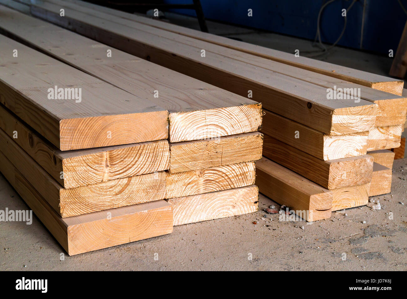 Stack of new wooden studs at the lumber yard. Wood timber construction ...
