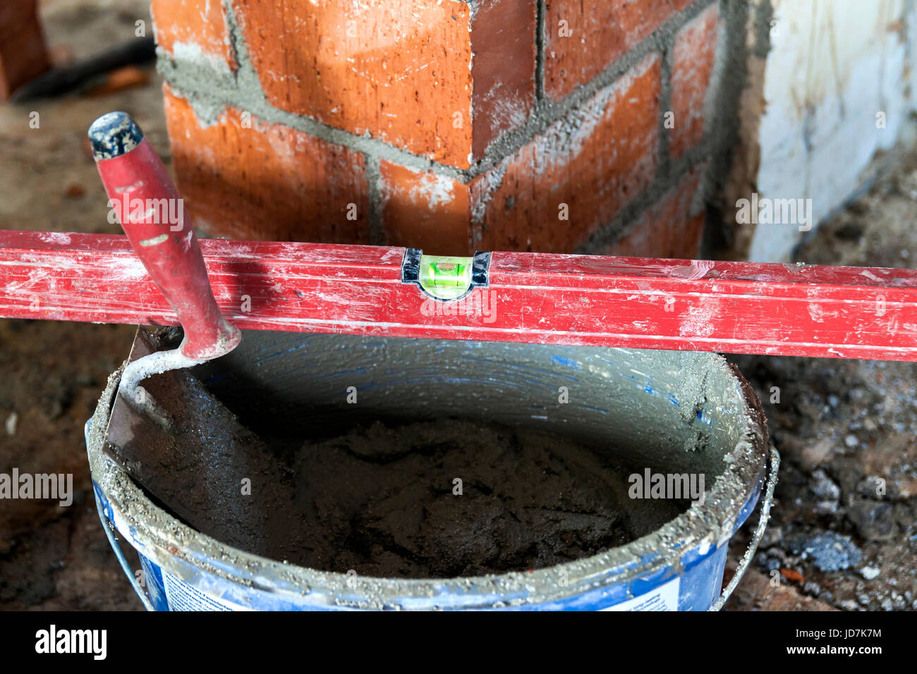 Close up of bricklaying industrial installing bricks on construction ...