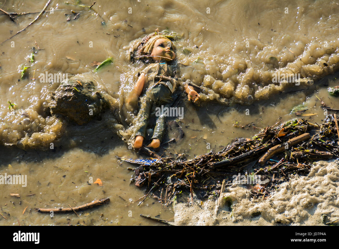 A child's doll floating forlornly in the River Thames, London, UK Stock ...