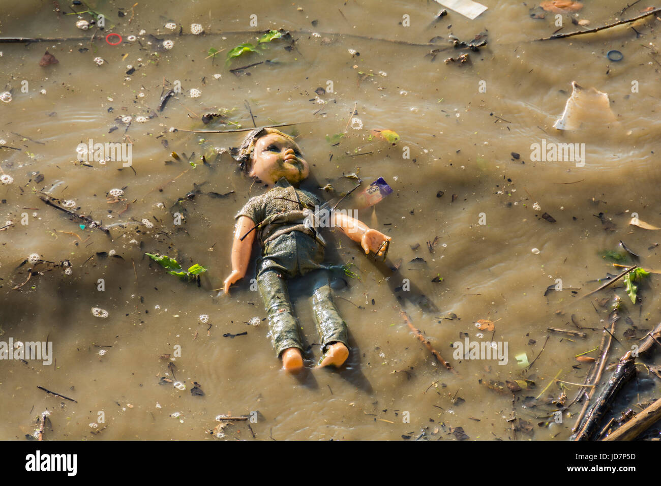 A child's doll floating forlornly in the River Thames, London, UK Stock ...