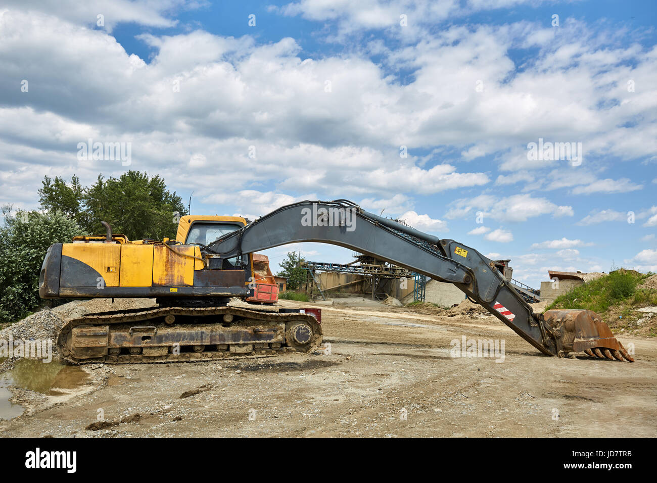 Excavator at the digging site in a sunny day Stock Photo - Alamy