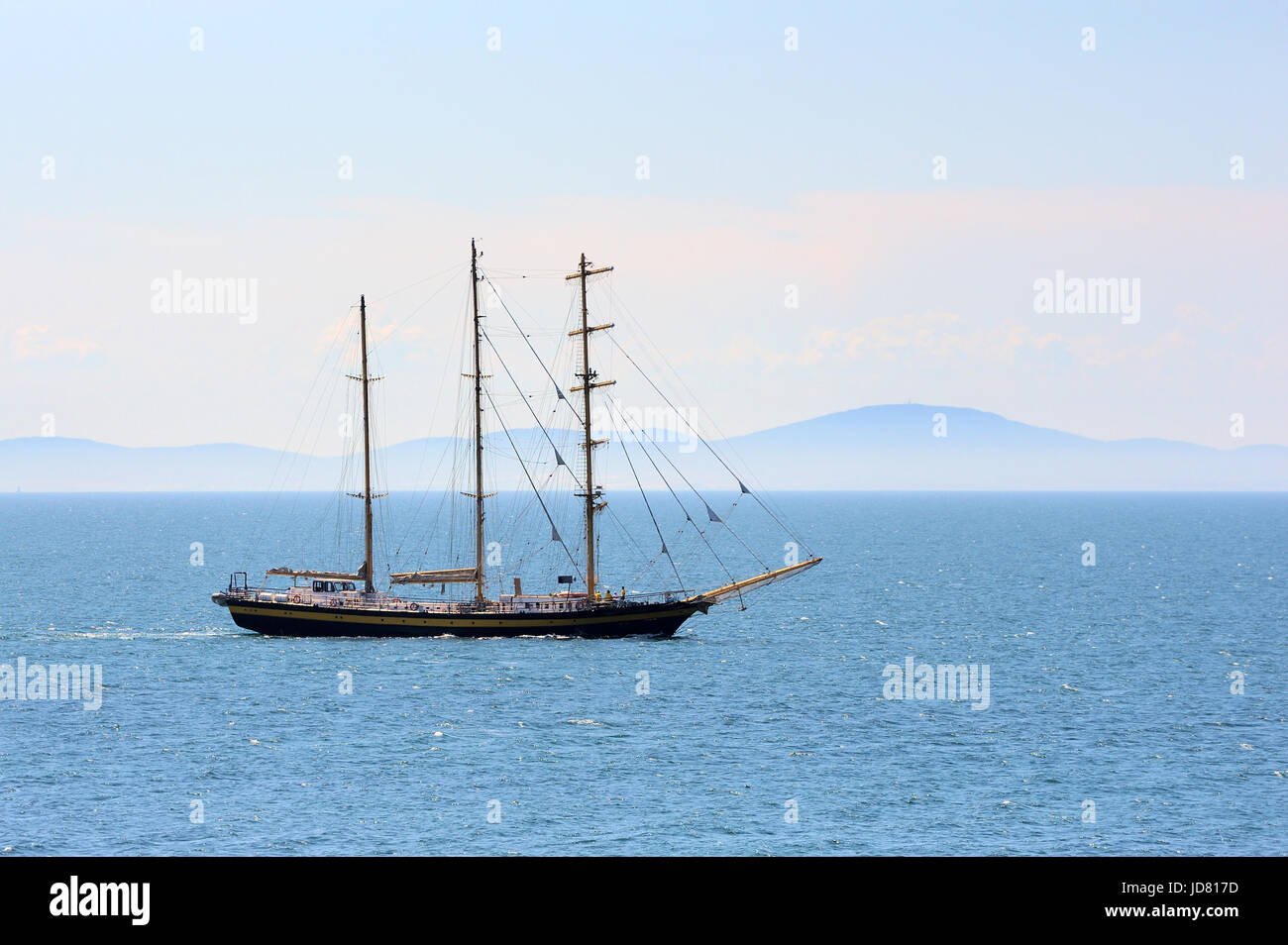 Ship sailing in the sea on mountain background Stock Photo - Alamy