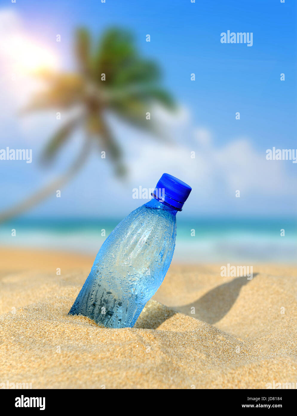 Bottle of the fresh water on the beach with palm Stock Photo - Alamy