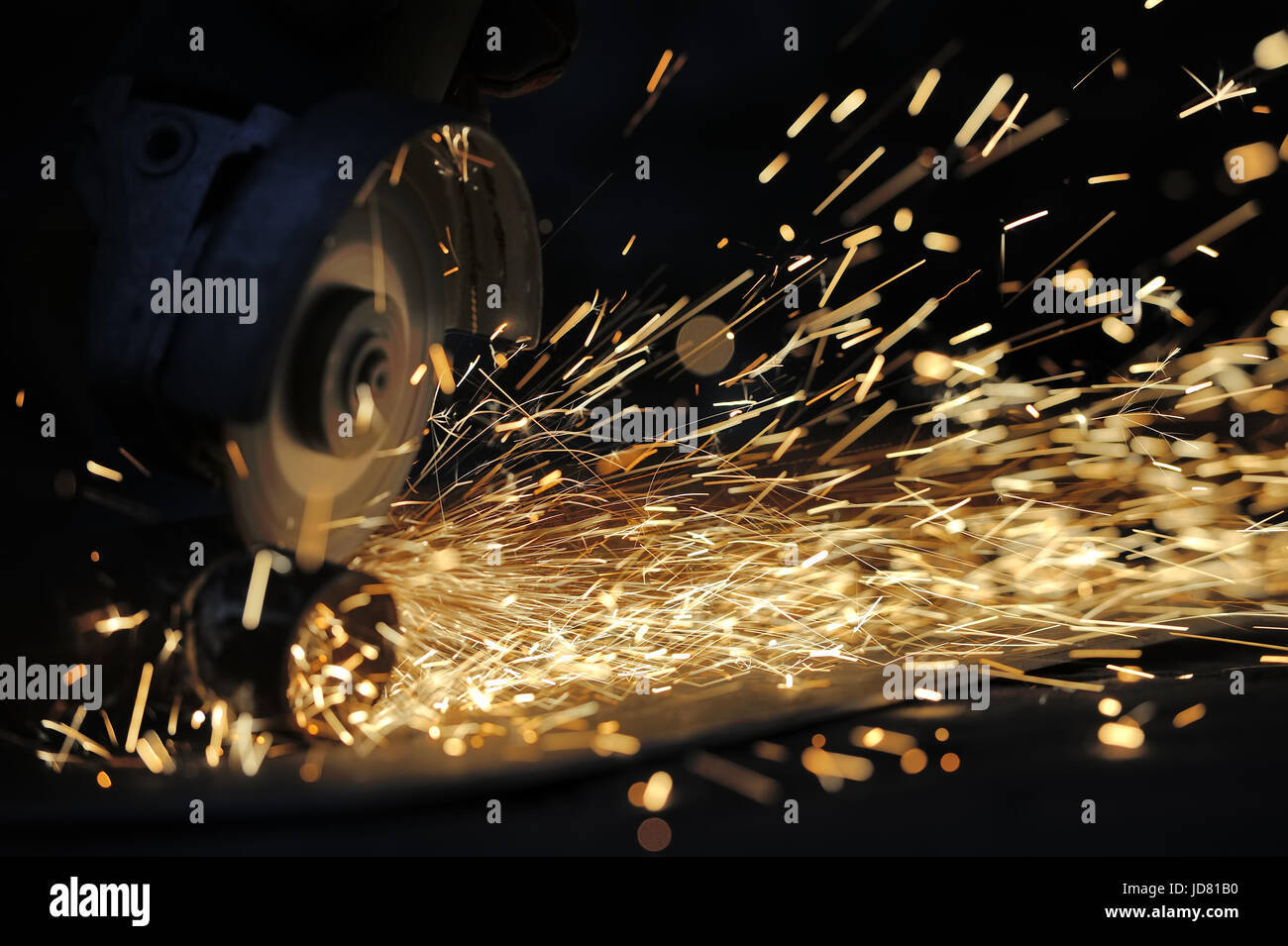 Worker cutting metal with grinder. Sparks while grinding iron Stock ...