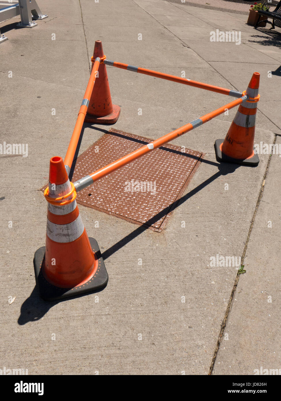 Manhole cover barricaded Stock Photo - Alamy