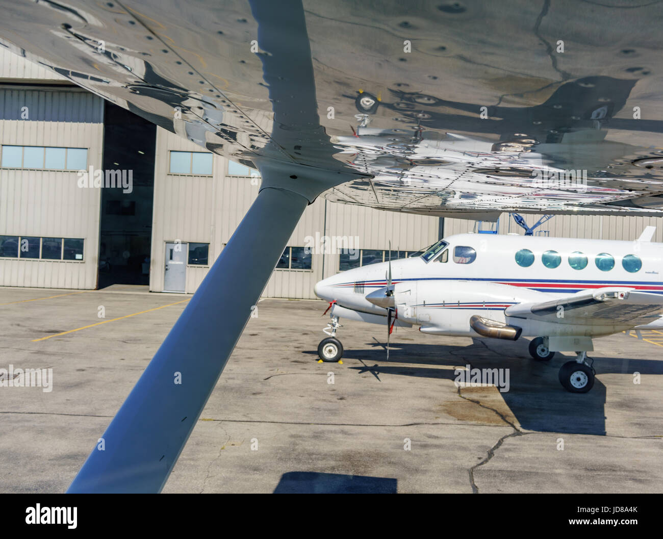 View of light aircraft from underneath a plane on sunny day. aerial ...