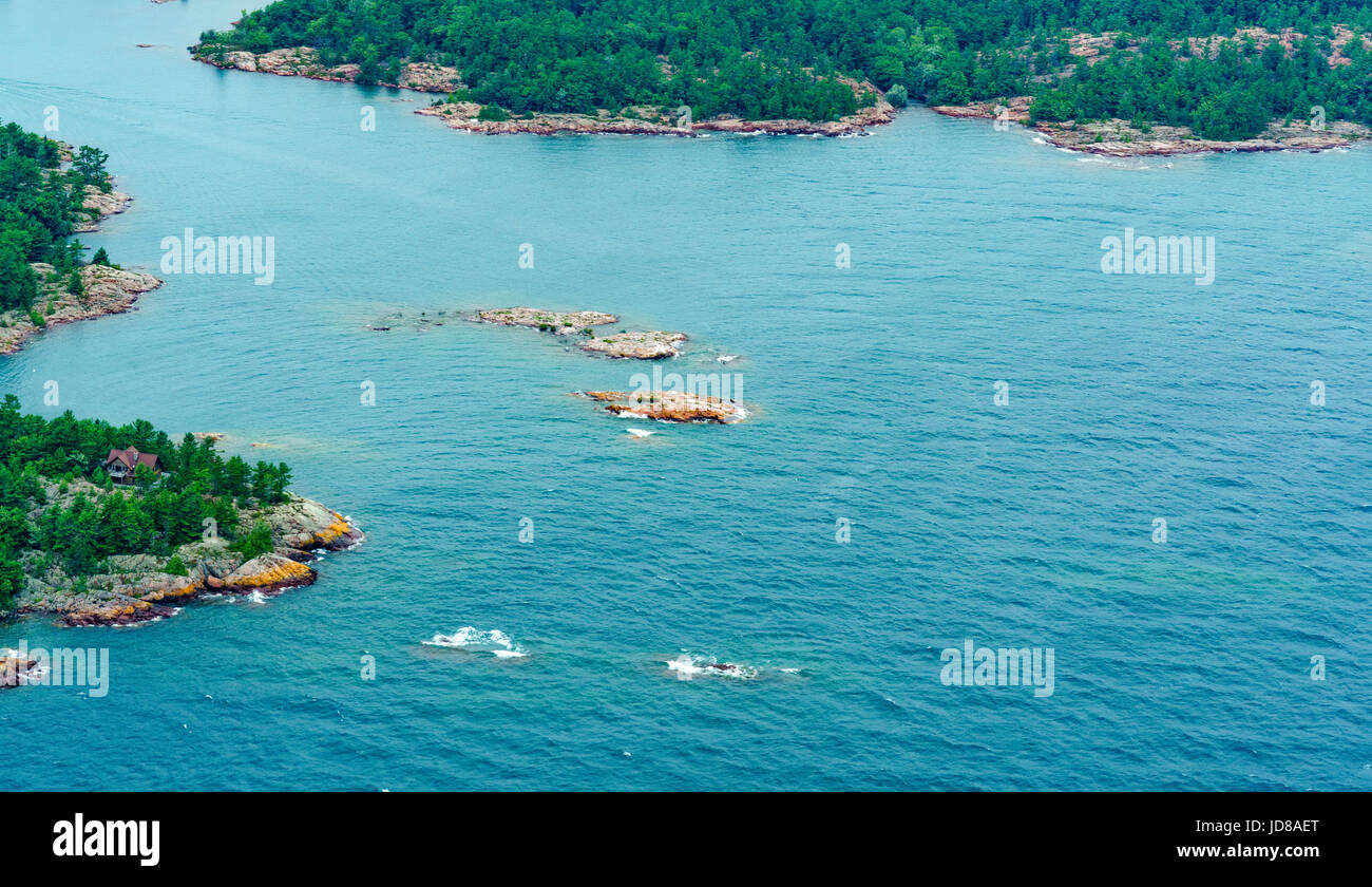 High angle view of coastline with trees and offshore rocks, Toronto ...