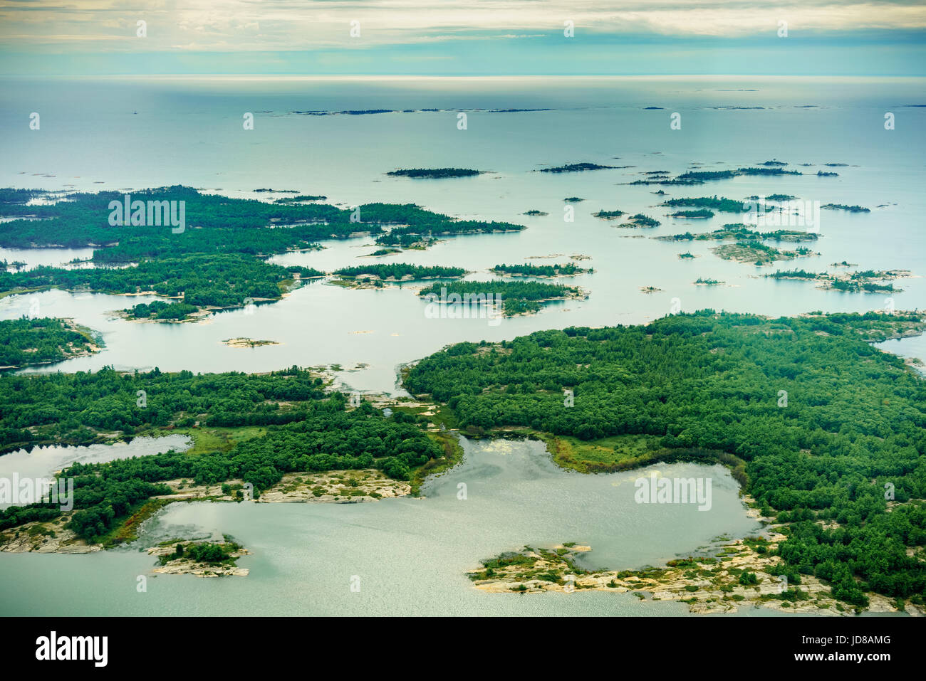 High angle view of coastline with trees and offshore rocks, Toronto ...