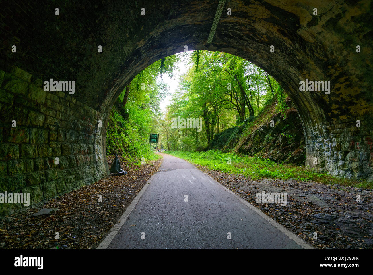 Empty tunnel with stone walls view along road through archway hi-res ...