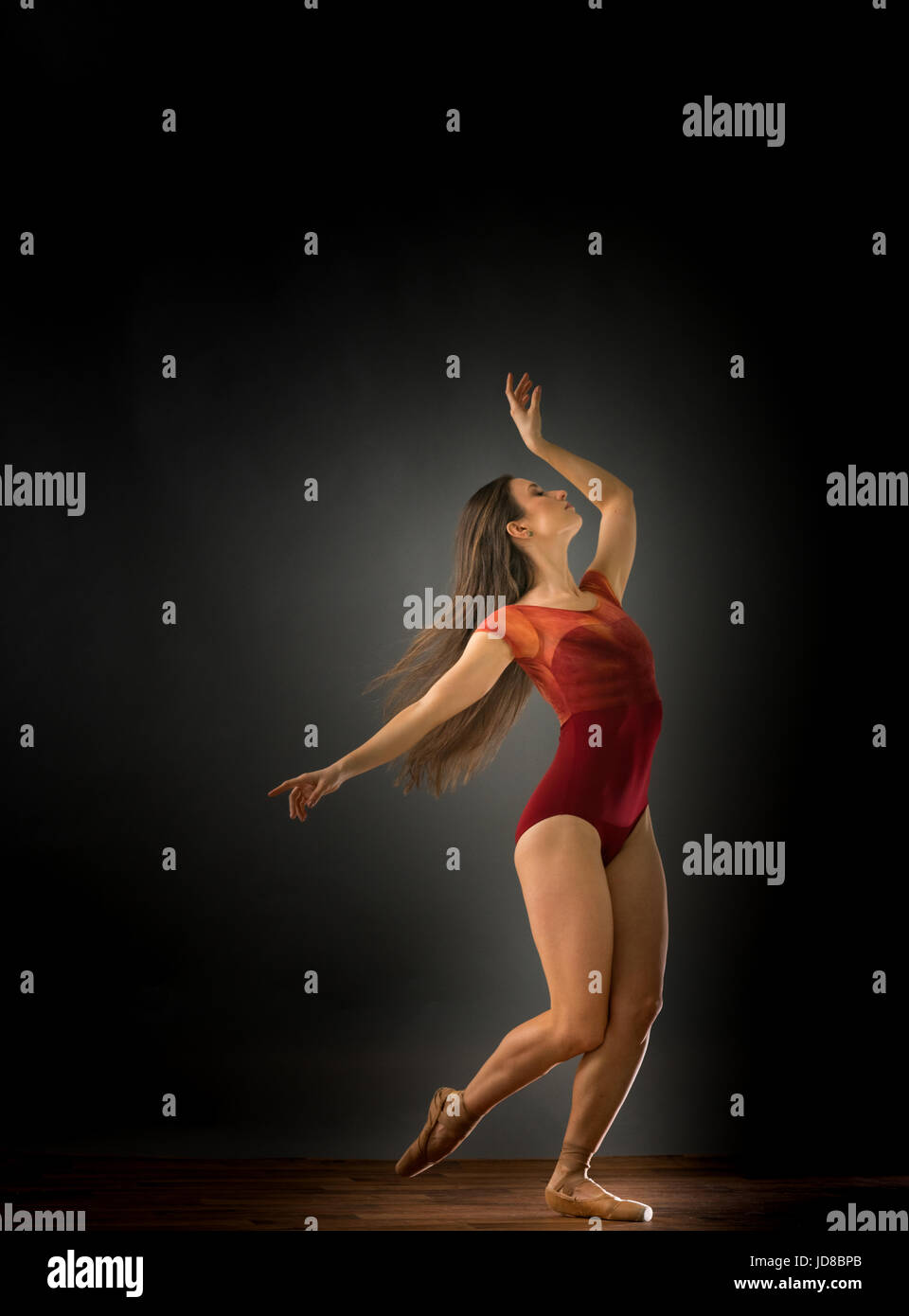 Female ballet dancer with arm lifted standing on one foot hi-res stock ...