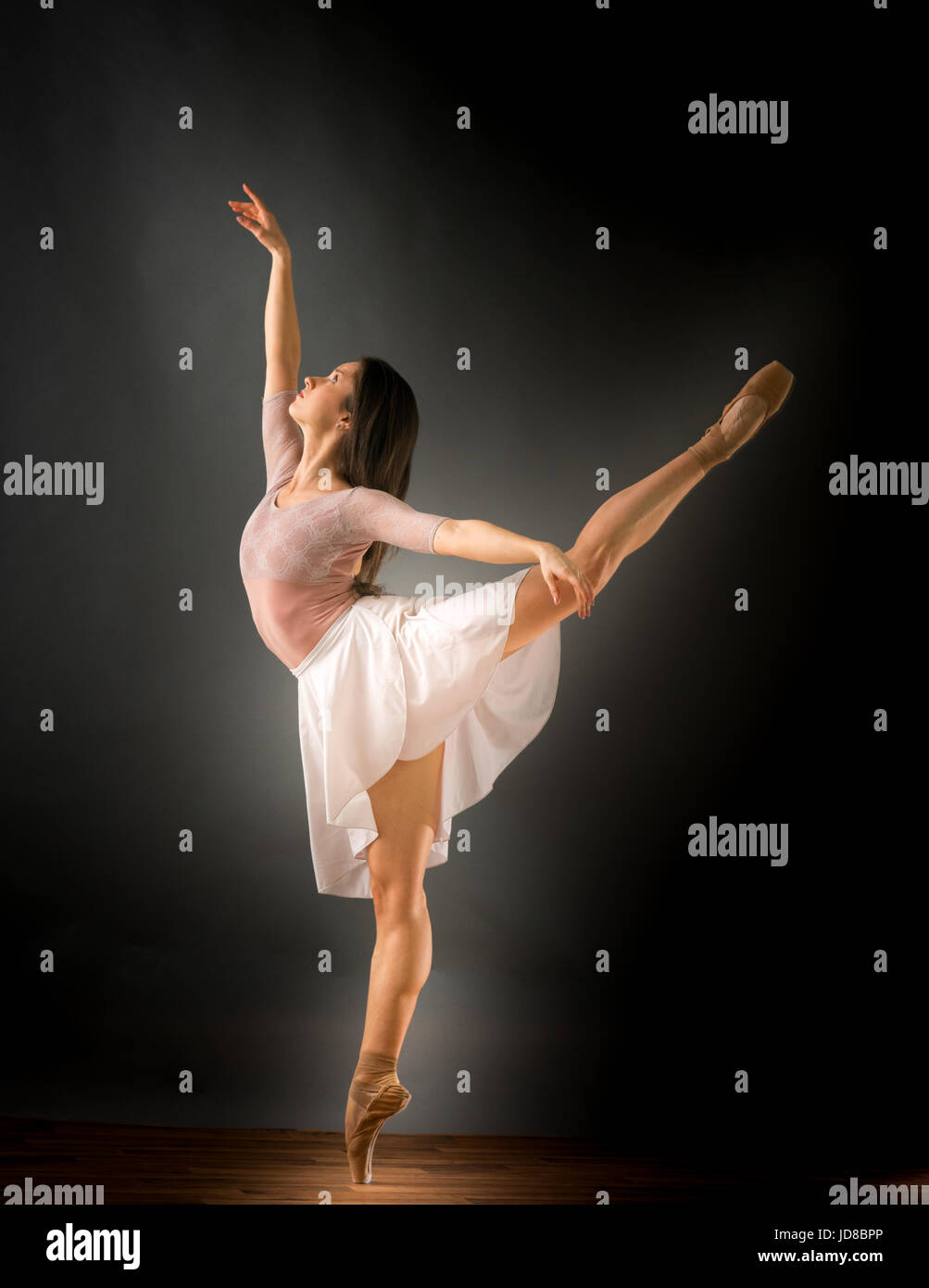 Female ballet dancer on one leg with arms stretched hi-res stock ...