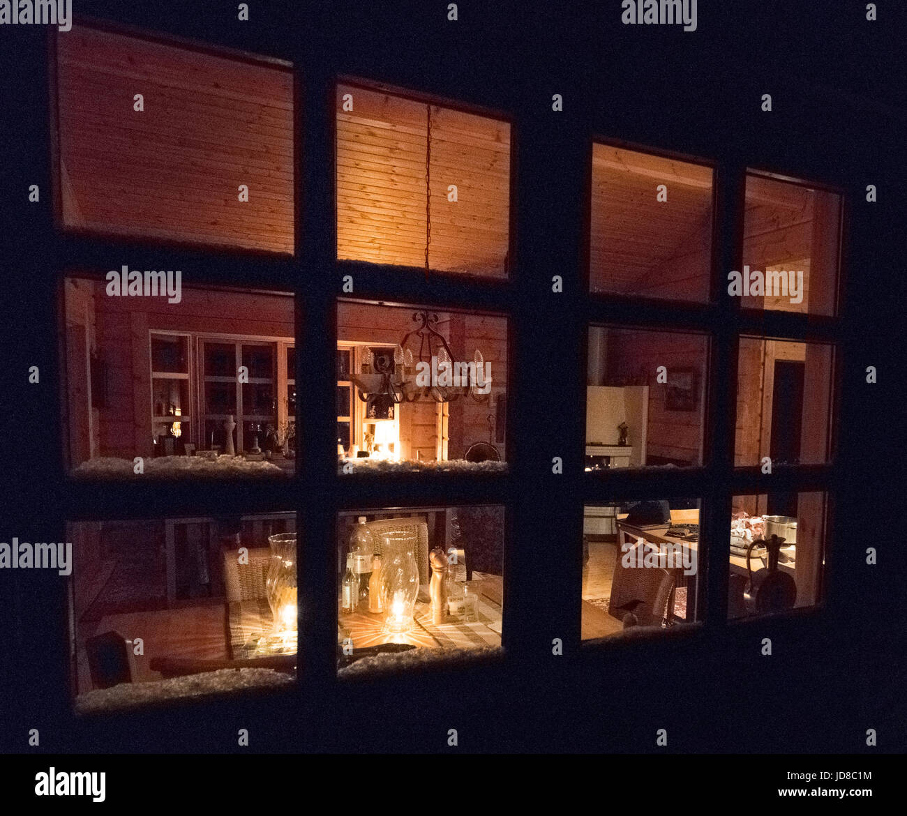 Looking through window into dining area of log cabin, Iceland, Europe ...
