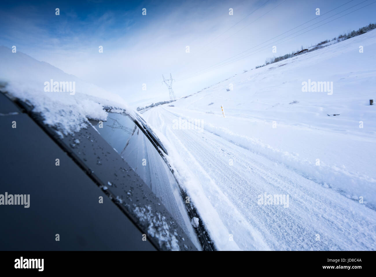 Vehicle driving through deep snow covered landscape by day, Iceland ...